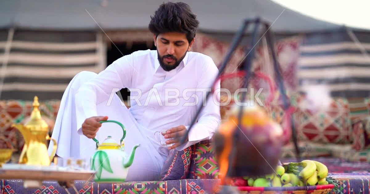 A young Saudi man drinks tea in the morning atmosphere, a Saudi man ...
