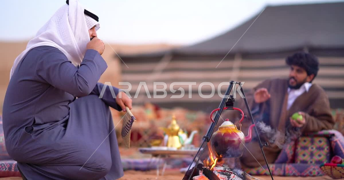 Young Saudis enjoy drinking Arabic coffee in a wild session, a morning ...