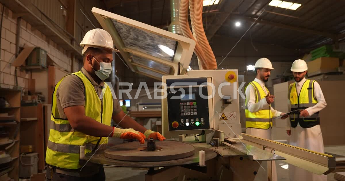 A group of Saudi Gulf Arab engineers wearing helmets and protective ...
