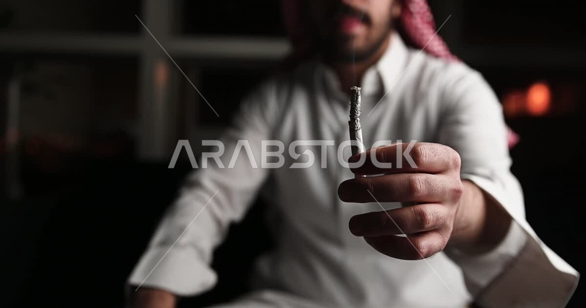 A young Saudi Arab fights against the smoking habit, gestures ...