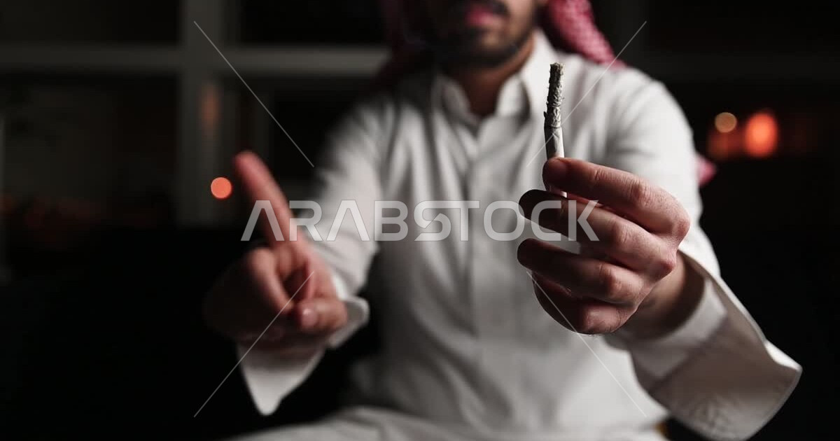 A young Saudi Arab fights against the smoking habit, gestures ...