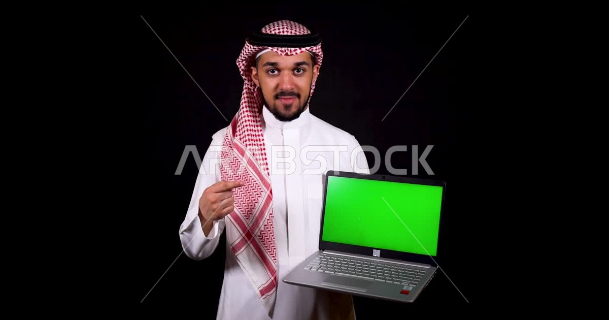 Chroma of a Saudi Arabian Gulf Arab man holding a laptop in his hand ...
