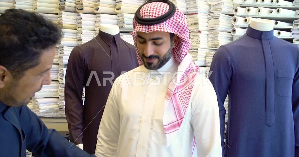 A young Saudi Gulf man working in the profession of sewing, he takes ...