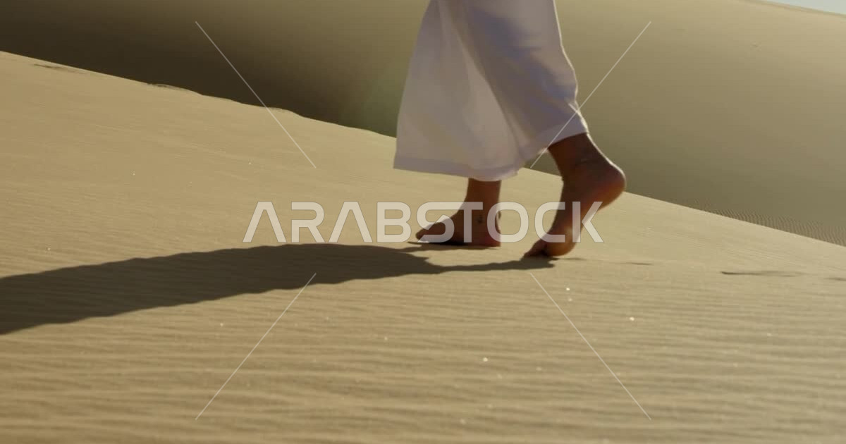 Enjoying the desert scenery, close-up of the feet of a young Saudi ...