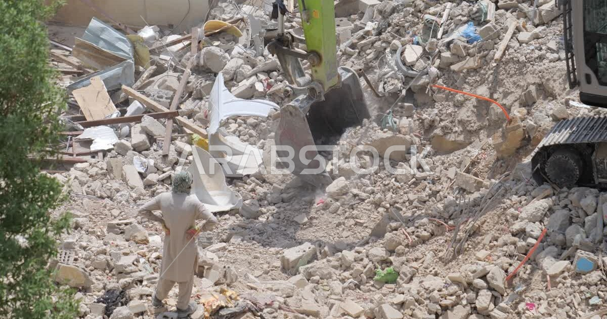 Demolition of a residential building in Saudi Arabia, an excavator ...