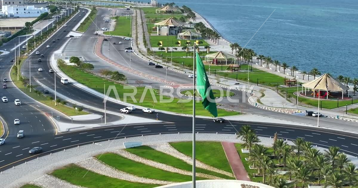 Waterfront, towers, skyscrapers and hotels, aerial view of Saudi flag ...