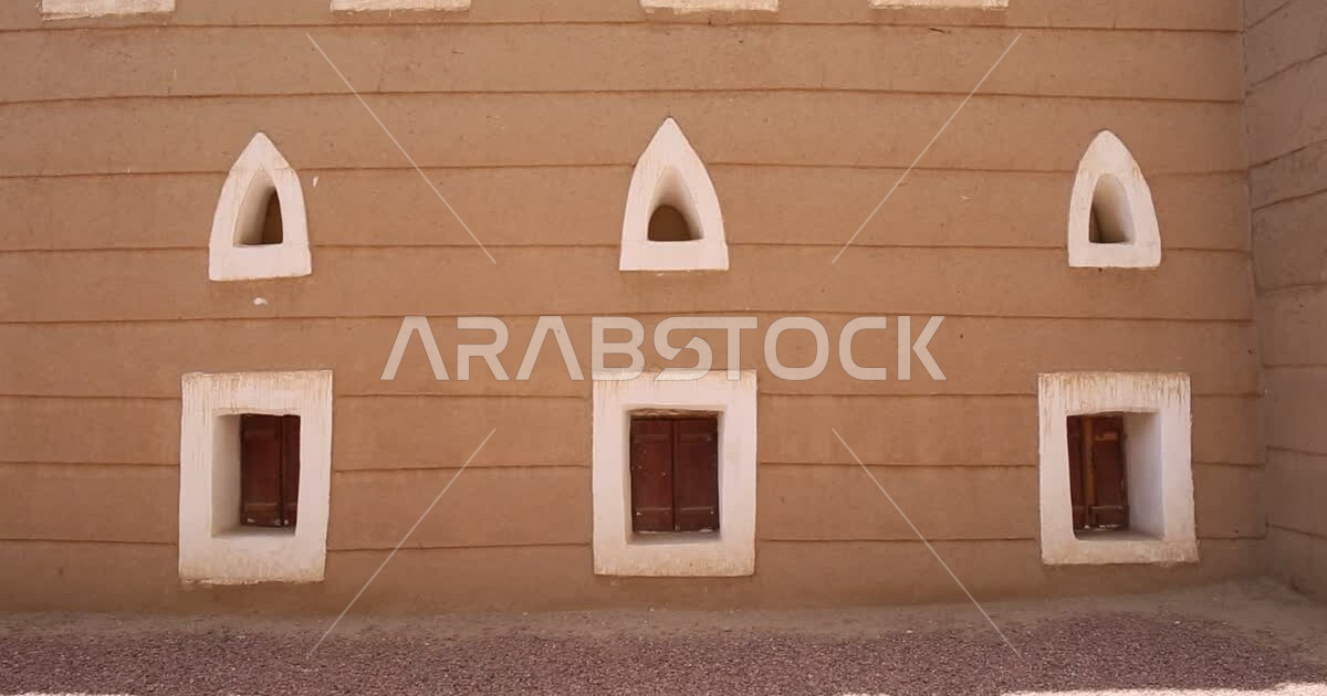 Wooden windows built in the old mud style, a Saudi Arabian Gulf man ...