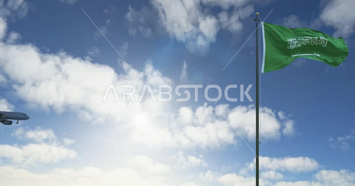 Saudi flag flying high with plane flying amidst white clouds in the sky ...