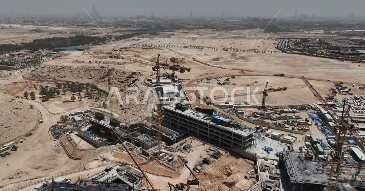 Construction cranes, concrete pouring and foundation laying ...