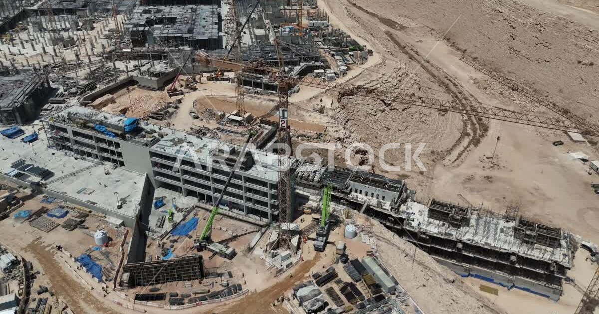 Construction cranes, concrete pouring and foundation laying ...