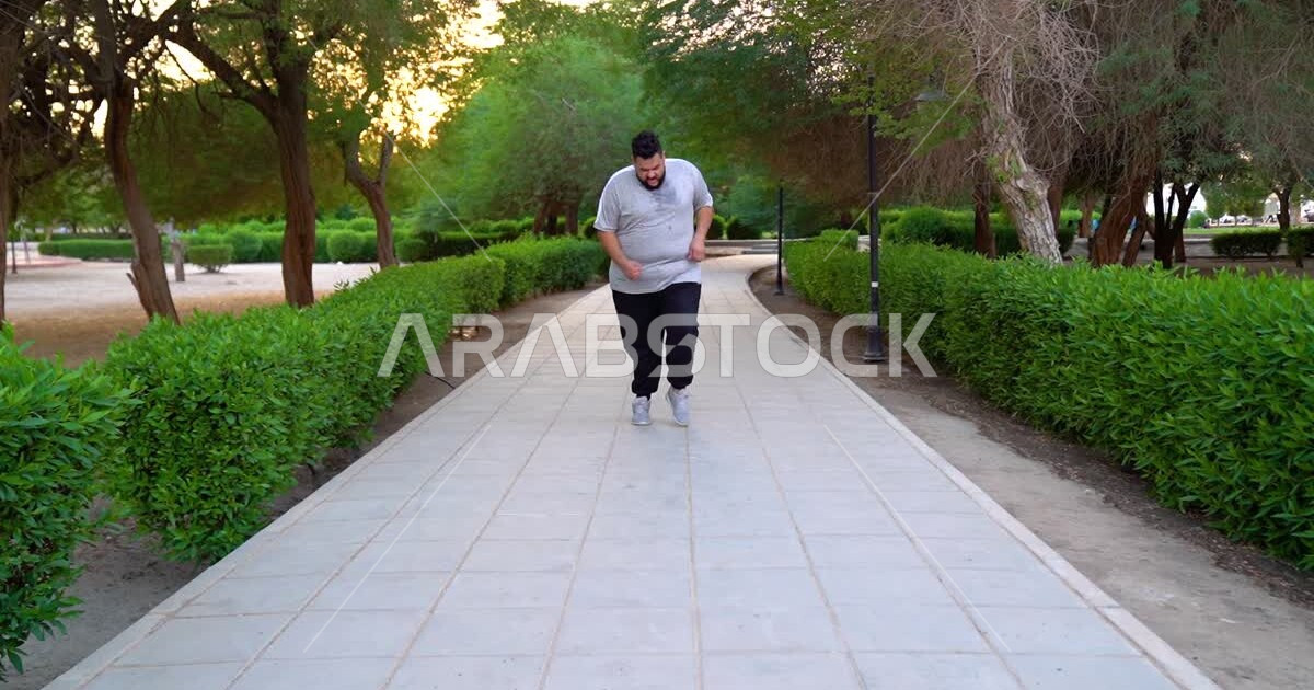 A young Saudi Gulf Arab practicing outdoor morning sports, walking ...