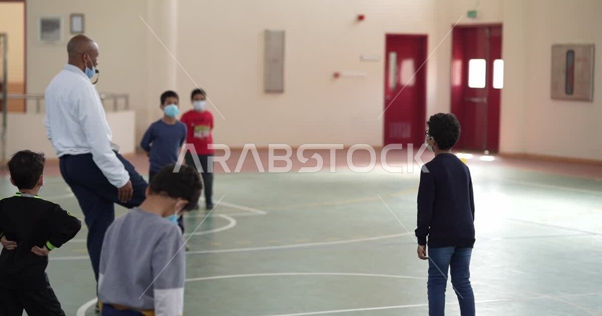 A group of Saudi Arabian Gulf students playing football in the school's ...