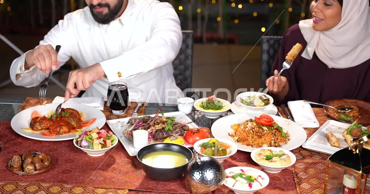 A Saudi Arabian couple at the breakfast table in the month of Ramadan ...