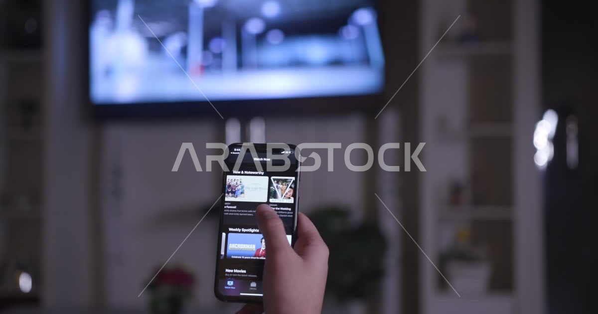 A young Saudi Arabian Gulf youth displays the mobile phone screen on ...