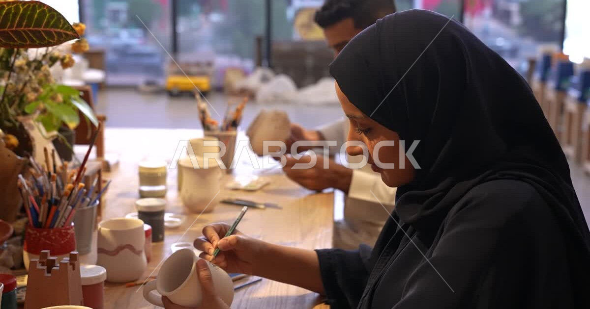 Professional Saudi Arabian Gulf working in the art workshop, practicing ...