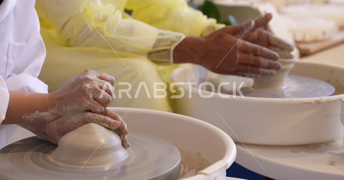 Practicing pottery making skill, close-up of hands of Saudi Arabian ...