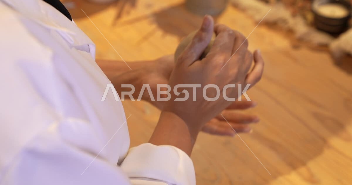 Practicing pottery skill, art of making ceramics and pottery in Saudi ...