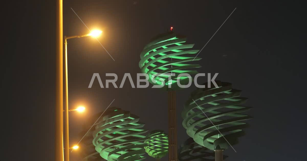 Illuminated art sculptures in the form of green trees at night in Arqa ...