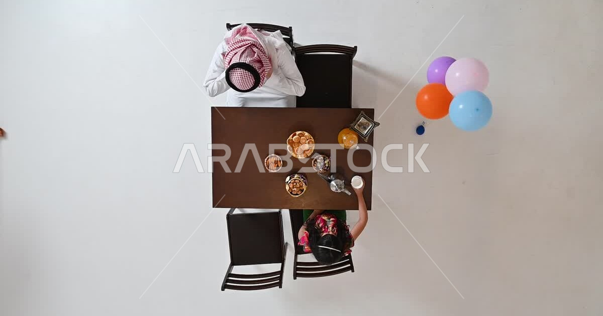 Family gathering at the dining table, gestures of happiness and joy at ...