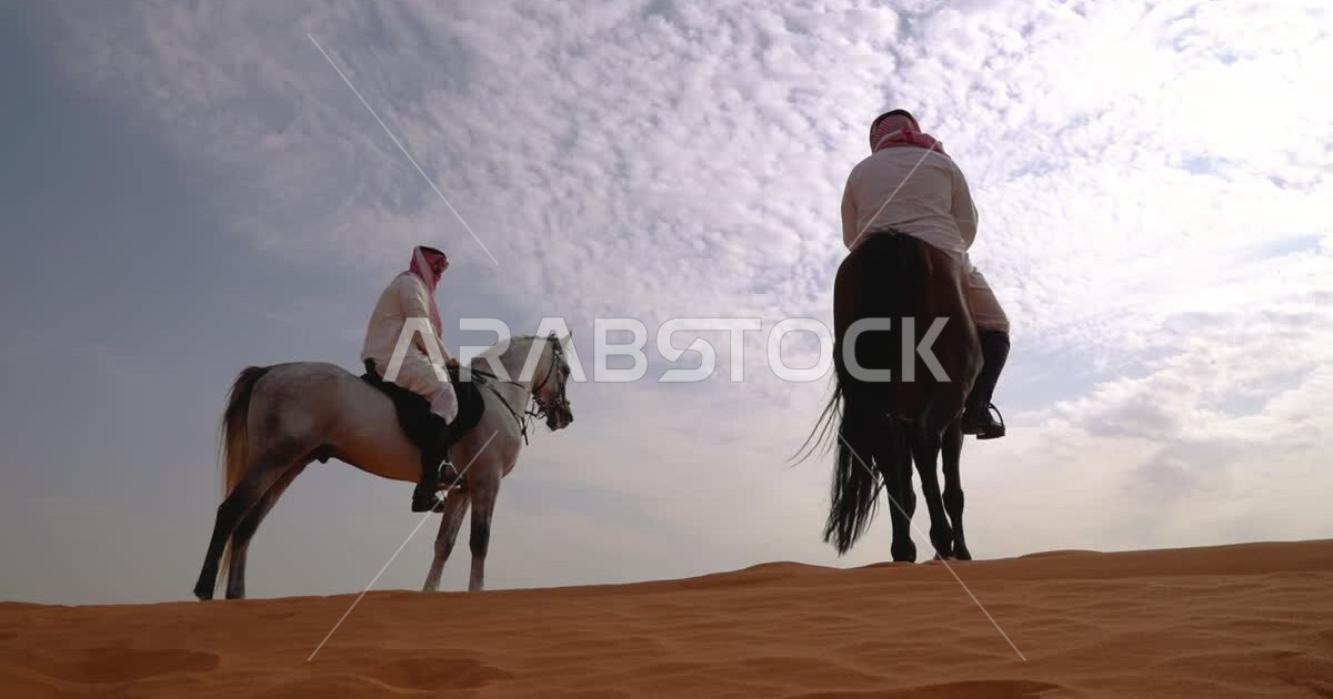 Two Saudi Arabian Gulf riders riding horses in the picturesque Saudi ...