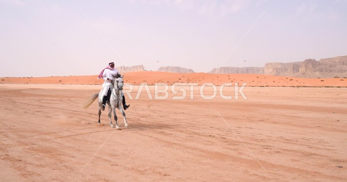 A Saudi Gulf rider riding horses at high speed in the picturesque Saudi ...