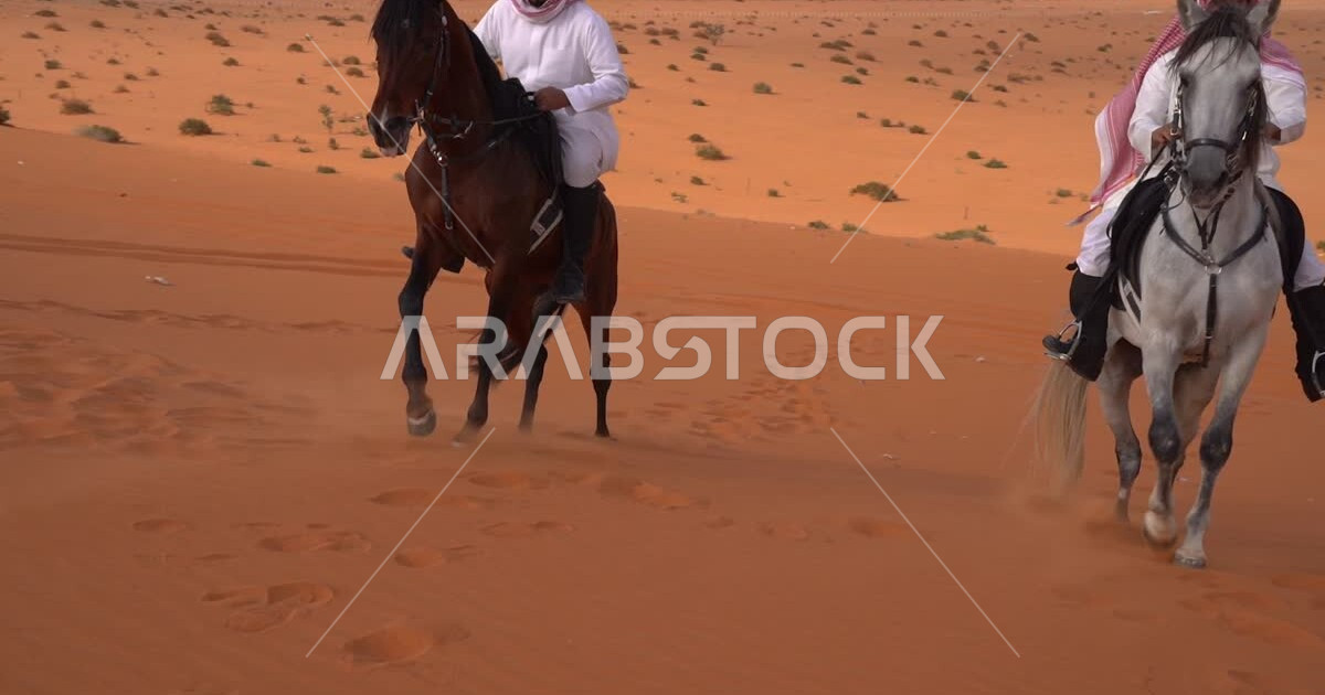 Two Saudi Arabian Gulf riders riding horses in the picturesque Saudi ...