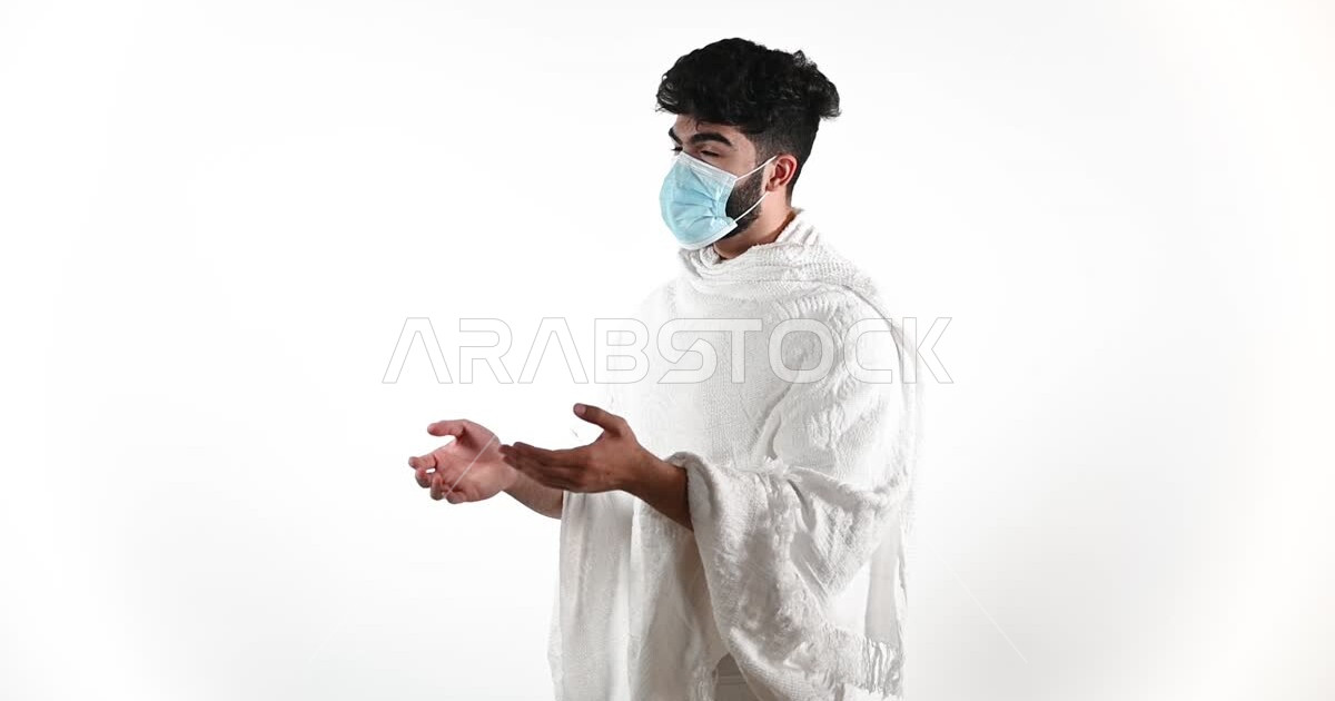 Portrait of a Saudi Arabian Gulf Muslim man in Ihram dress wearing a ...