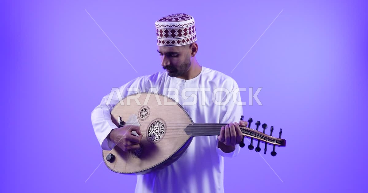 Enjoying playing classical stringed instruments, a young Gulf Arab ...