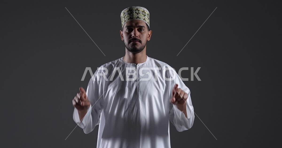Raising the hands up with oath gestures, a portrait of a young Arab ...