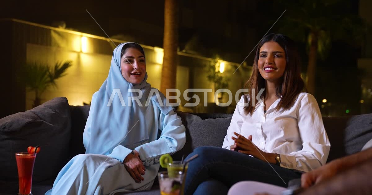 Weekend with friends, close-up of two Omani Arab women sitting on the ...