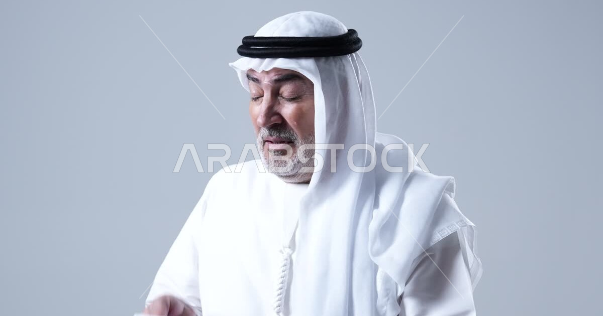 Allergic rhinitis, close-up of elderly Arab Emirati Gulf man wearing ...