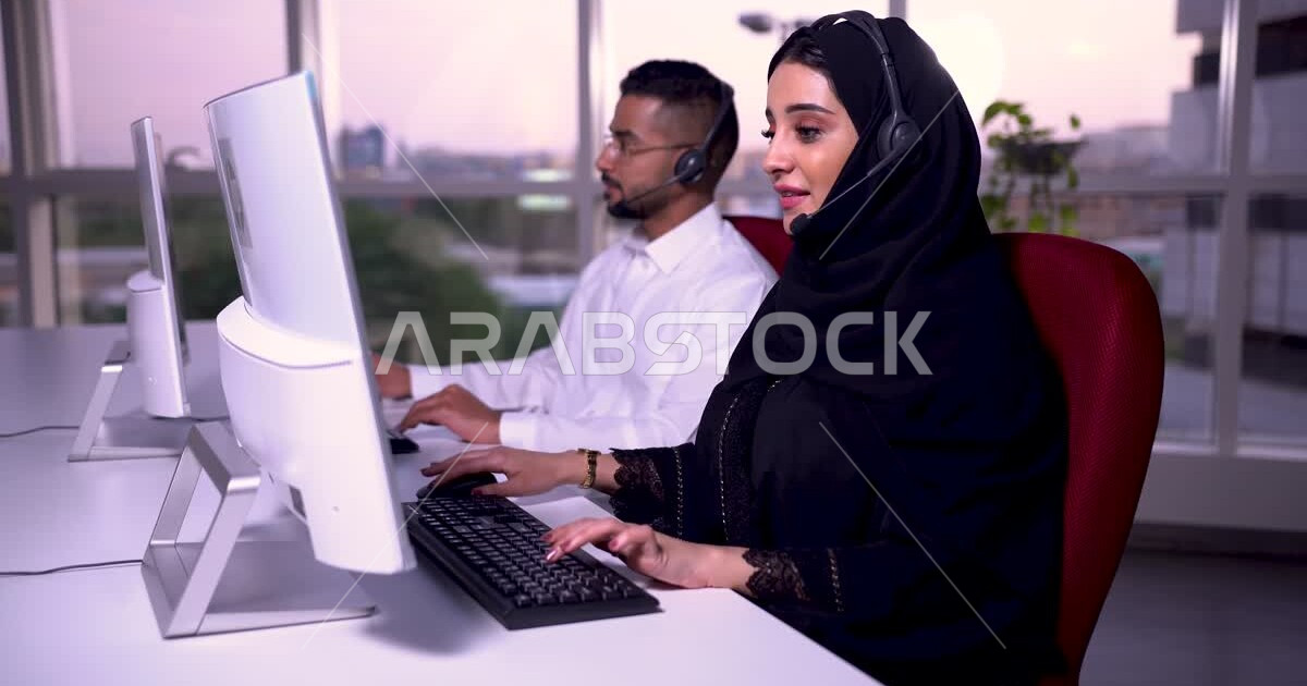 Two Saudi Arabian Gulf employees working in customer service, an ...