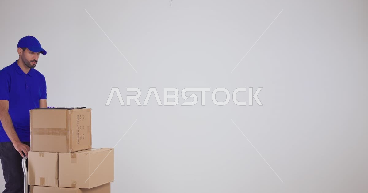 Young Saudi Arabian Gulf man working on delivering orders, receiving ...