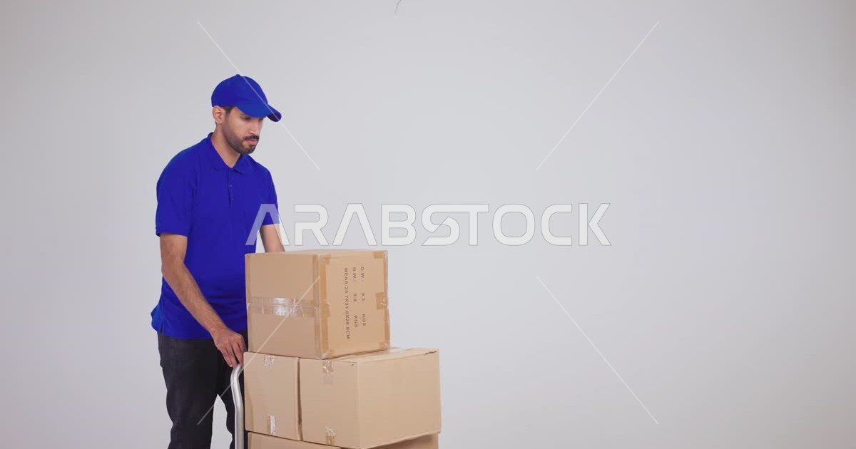 Young Saudi Arabian Gulf man working on delivering orders, receiving ...