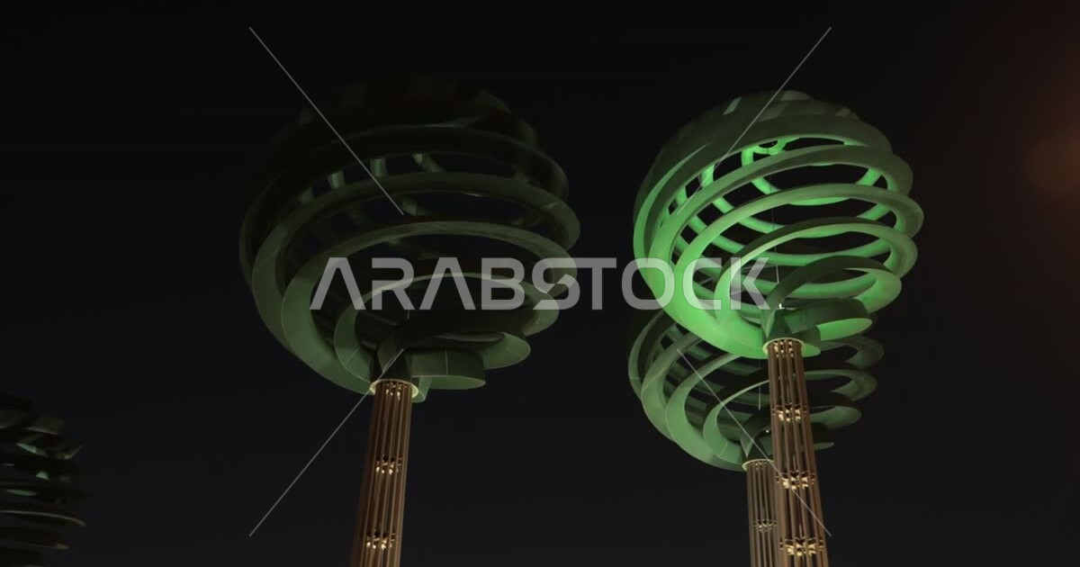 Illuminated art sculptures in the form of green trees at night in Arqa ...