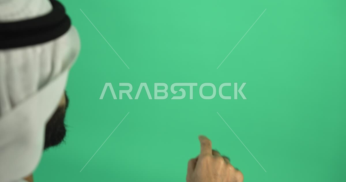 Pointing index finger somewhere, close up from back of an Emirati Gulf ...
