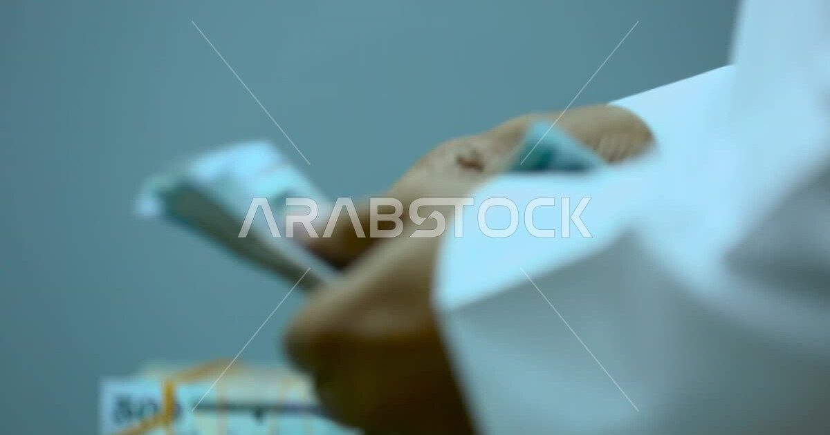 Saving and saving money, paper money, close-up of a Saudi Arabian Gulf ...