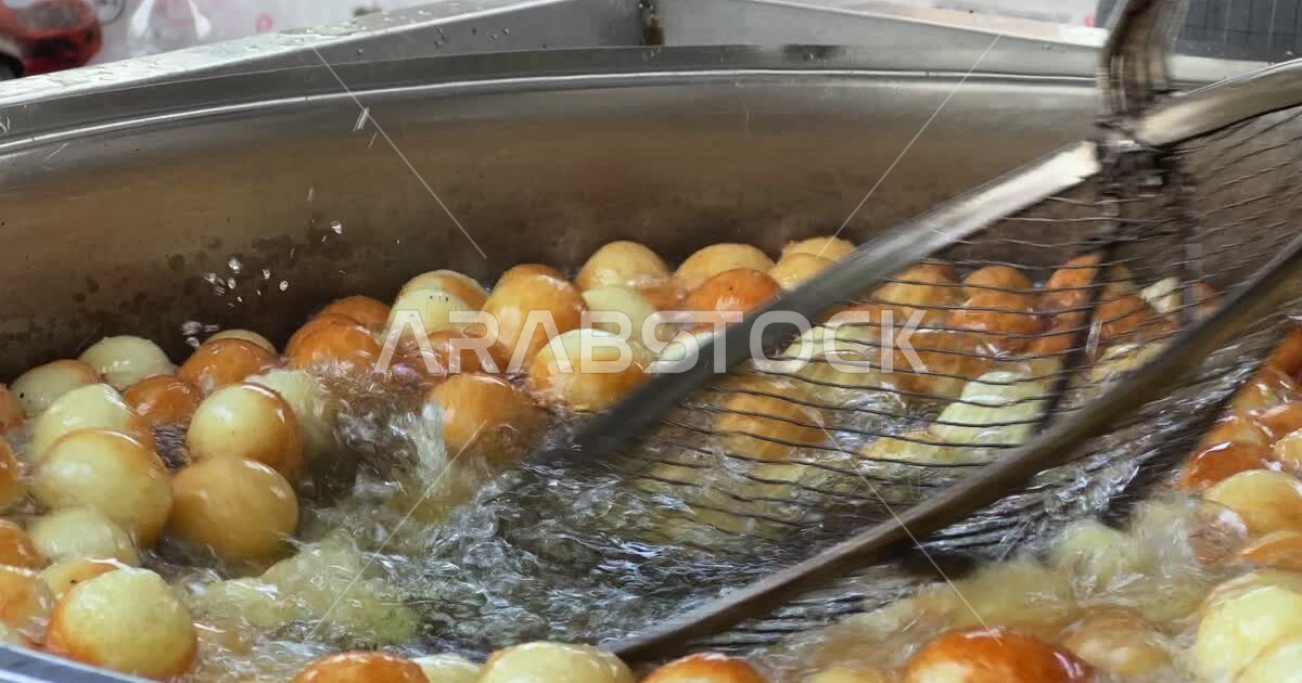 Delicious golden Luqaimat dessert, oriental Zalabiyat dessert, close-up ...