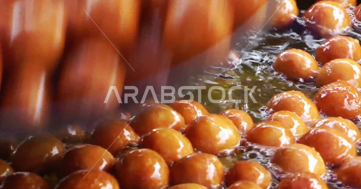 Delicious golden Luqaimat dessert, oriental Zalabiyat dessert, close-up ...