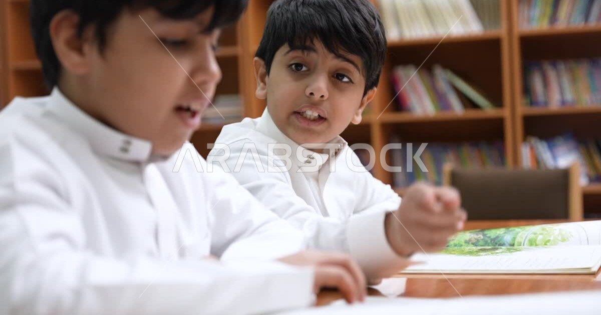 Two Saudi Arabian Gulf students sitting in the school library with ...