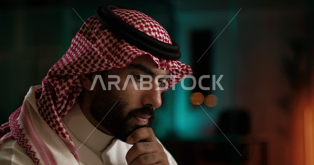 A Saudi Arabian Gulf businessman, using tablets and laptops to complete ...