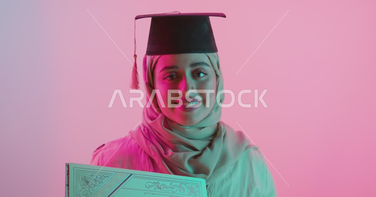 A veiled Saudi Arabian Gulf student holding a graduation certificate in ...