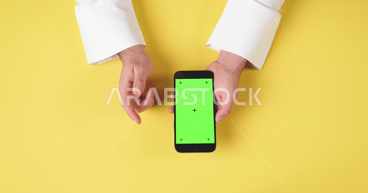 Close-up photography of the hand of a Saudi Arabian Gulf man using a ...