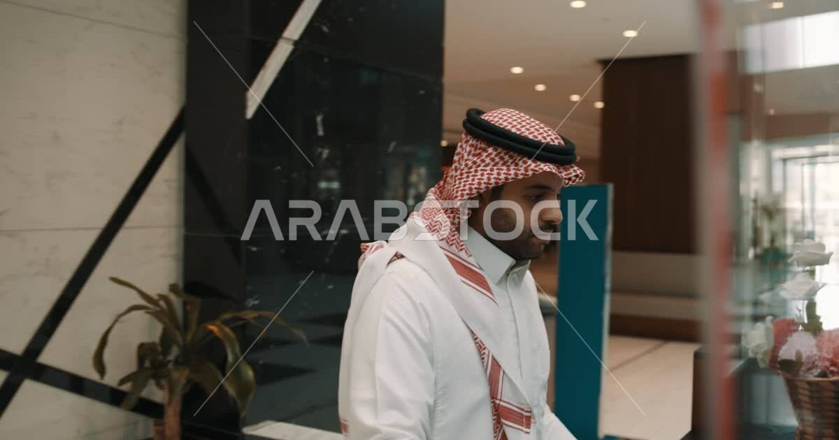 An Arab-Saudi Gulf receptionist enters data and information in the ...