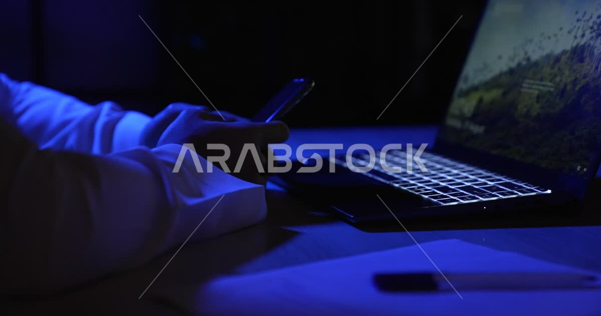 Close-up photography of the hand of a Saudi Arabian Gulf man using a ...