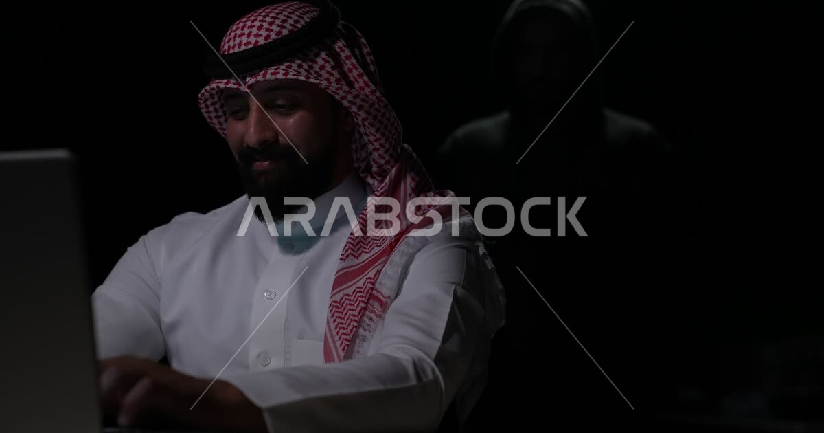 A Saudi Arabian Gulf man using his laptop, exposure to hacking and ...
