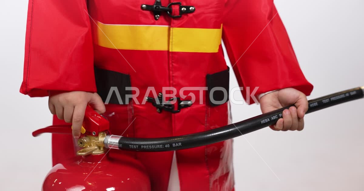Portrait of a stylish Saudi Arabian Gulf boy, dressed as a firefighter ...
