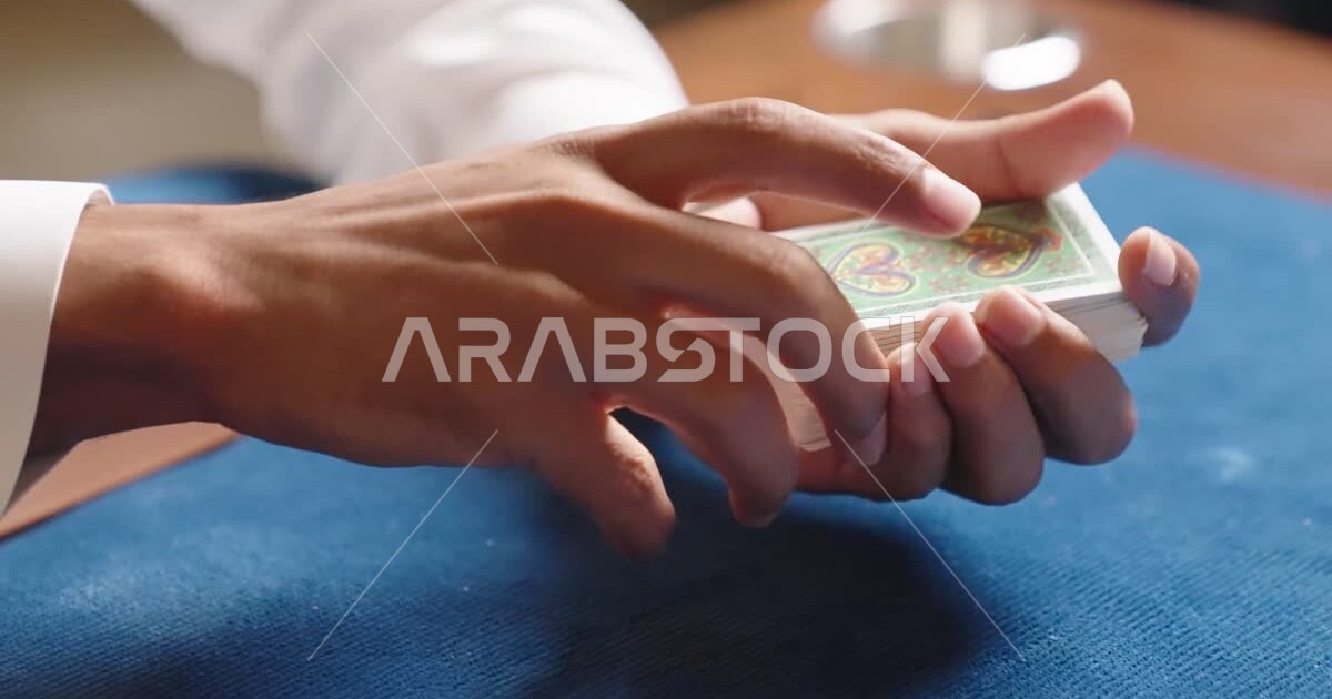 Close-up depiction of the hand of a Saudi young man holding a set of ...