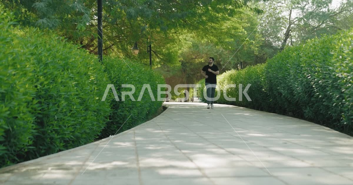 An Arab man doing morning sports in the open air, jogging, exercising ...