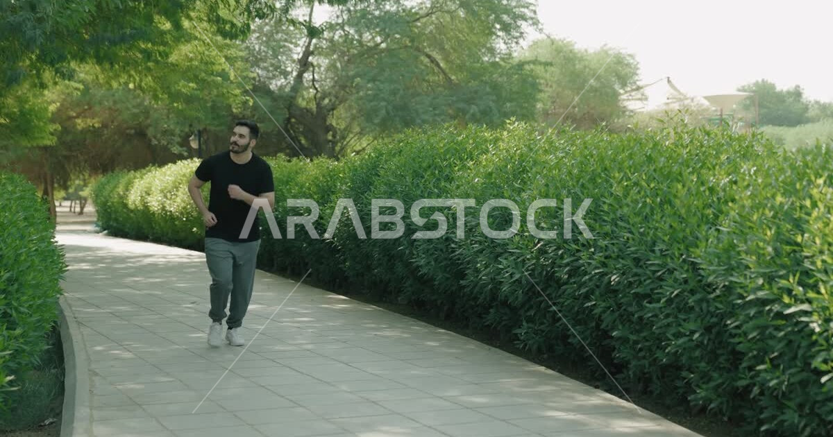An Arab man doing morning sports in the open air, jogging, exercising ...